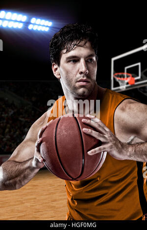 Basketball player on a orange uniform, on a black background Stock ...
