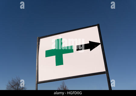 A medical green cross marijuana sign on the exterior of a dispensary in ...