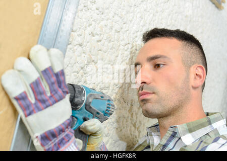 Builder with a cordless drill Stock Photo - Alamy