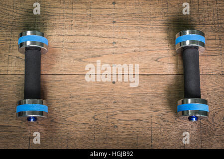 Fitness equipment on wooden background. Dumbbells, sneakers, measuring ...