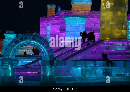 Tourists visit the Harbin Ice and Snow World during the peak ice-snow ...