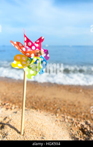 Colorful toy wind turbine at the beach Stock Photo - Alamy