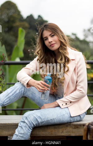 Cute young woman drinking water in plastic bottle close-up, healthy lifestyle Stock Photo - Alamy