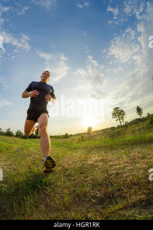 Male runner feet with blue sneakers stadium track, close up. Sport ...