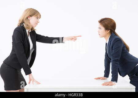 Two young women glaring at each other Stock Photo - Alamy