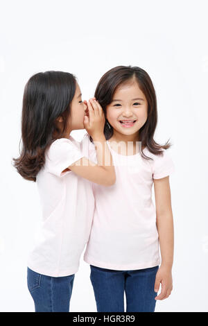 a girl student talking in a whisper to a boy student Stock Photo - Alamy