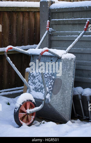 wheelbarrow in the snow Stock Photo - Alamy
