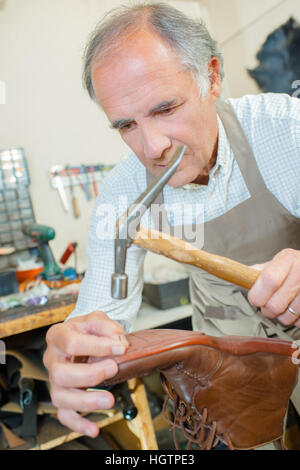 the focused cobbler Stock Photo - Alamy