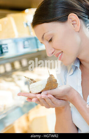 Woman smelling cheese Stock Photo - Alamy