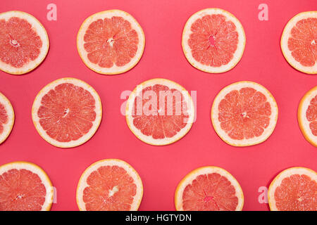 Cross sections of grapefruit against orange background Stock Photo - Alamy