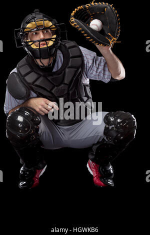 Baseball Player, catcher catching a wild pitch, on a black background ...