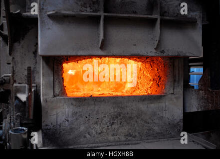 Looking into a melting furnace in a foundry for aluminum casting. 05.12 ...