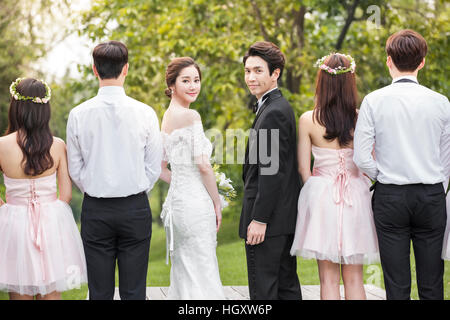 Back of wedding couple and their friends Stock Photo - Alamy