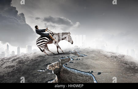 Young pretty fearless woman riding zebra animal Stock Photo - Alamy