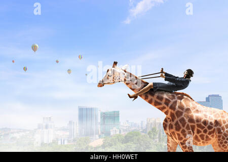 Young pretty fearless woman riding zebra animal Stock Photo - Alamy
