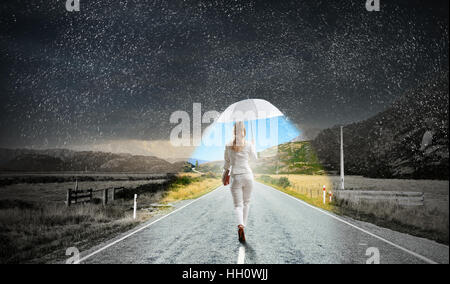 Elegant businesswoman hiding from rain under umbrella Stock Photo - Alamy