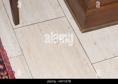 The broken tile floor. Damaged tile flooring caused by impact with ...