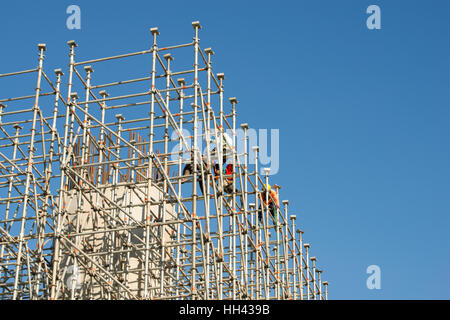 Construction building industry site workers below diagonal shoring ...