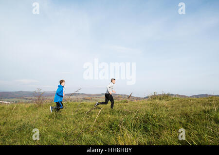 Two young hipster athletes running in sunny autumn nature Stock Photo ...