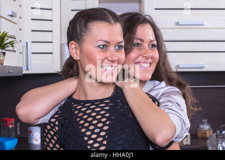 Happy twins close up portrait in the kitchen on background Stock Photo ...