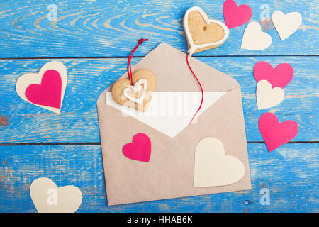 Envelope with card for Valentine's Day, cookie, candles and rose on ...