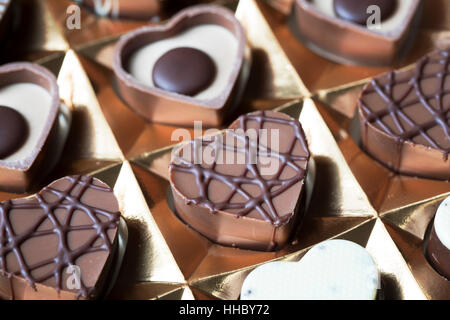 Close up of heart shaped chocolates on a wooden cutting board Stock ...