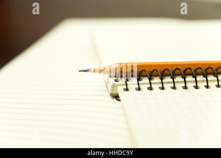 Pencil on the pages of an closed notebook Stock Photo - Alamy