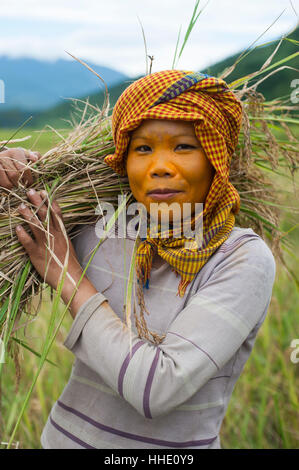A woman wearing a sun protection clothing walks at an outdoor shopping ...