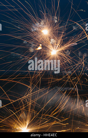 Low angle view of fireworks at beach against sky at night Stock Photo ...
