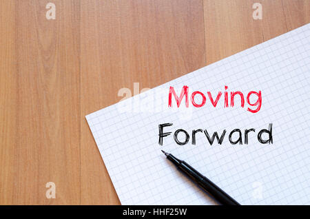 Moving forward text concept write on notebook Stock Photo - Alamy