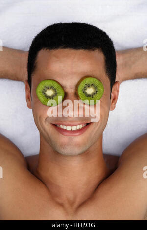 Man with kiwi slices on eyes Stock Photo - Alamy