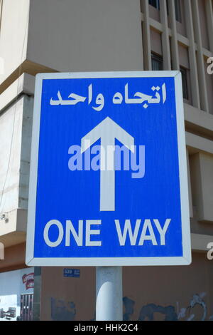 A sign in Arabic and English informing drivers to pay for parking at ...