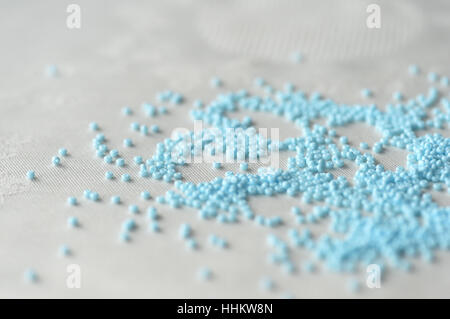 Scattered seed beads of light blue color close up Stock Photo - Alamy