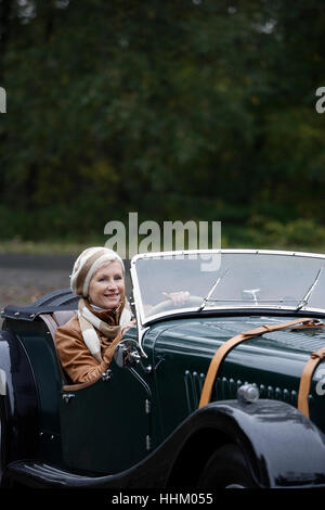 Woman driving antique car Stock Photo - Alamy