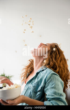 woman throwing up popcorn Stock Photo - Alamy