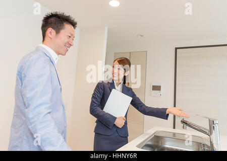 real estate agent showing a kitchen Stock Photo - Alamy
