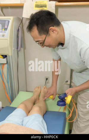 Legs Electrotherapy Performed by Doctor Stock Photo - Alamy