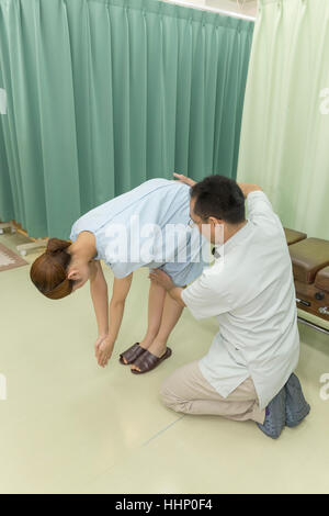 Doctor Manipulating the Body of A Woman Stock Photo - Alamy