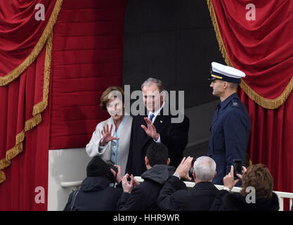 Former President George W. Bush (L) and his wife Laura Bush talk with ...