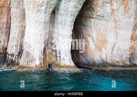 Coastal rock with caves and stone arches. Blue cave, natural landmark ...