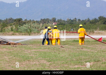 Firefighter in action spraying fire with fire hose Stock Photo - Alamy