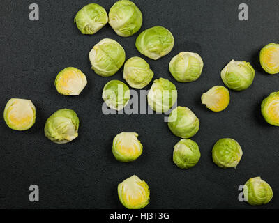 brussels sprouts ready for cooking isolated on a wooden background ...