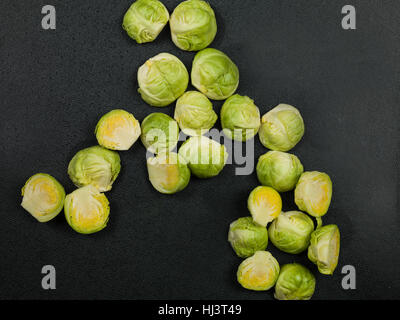 brussels sprouts ready for cooking isolated on a wooden background ...