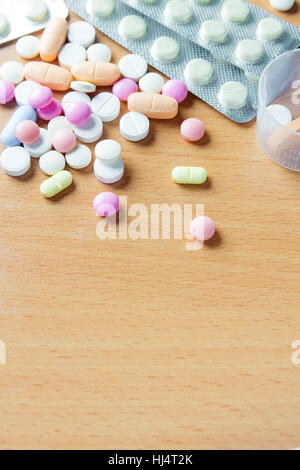 Medical concept. On the table are pills, a magnifying glass, pencils ...