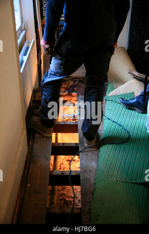 Floorboards are removed to expose dry rot in a house in south west ...