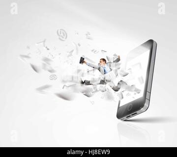 Image of businessman jumping out of mobile phone Stock Photo - Alamy