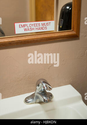 Restaurant employee washing hands in kitchen sink Stock Photo - Alamy