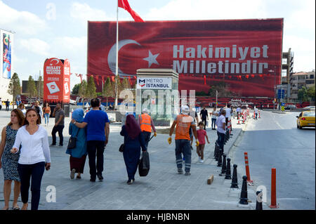 In Taksim Square, people are walking in front of the Atatürk monument ...