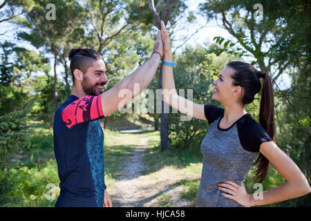 Couple high fiving in park Stock Photo - Alamy