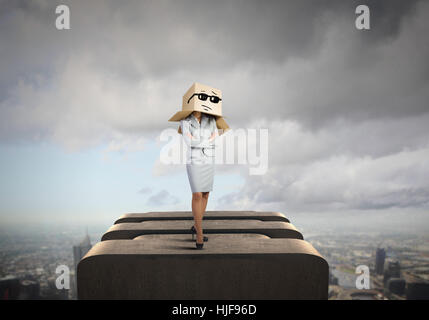 Businesswoman in suit wearing carton box on head Stock Photo - Alamy